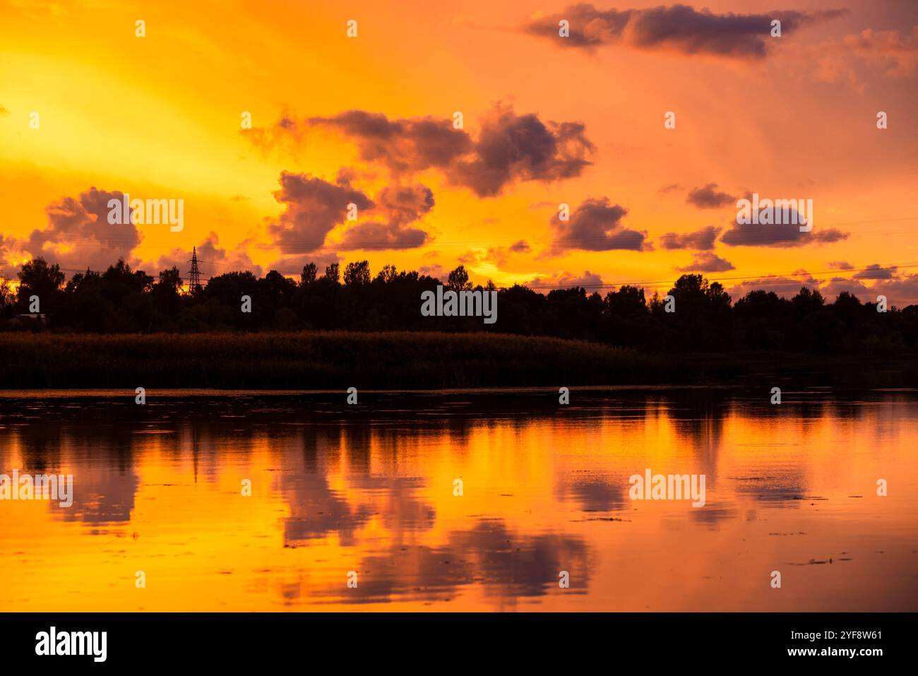 Amazing sunrise in rural scene. Symmetry of the sky in a lake at sunset ...