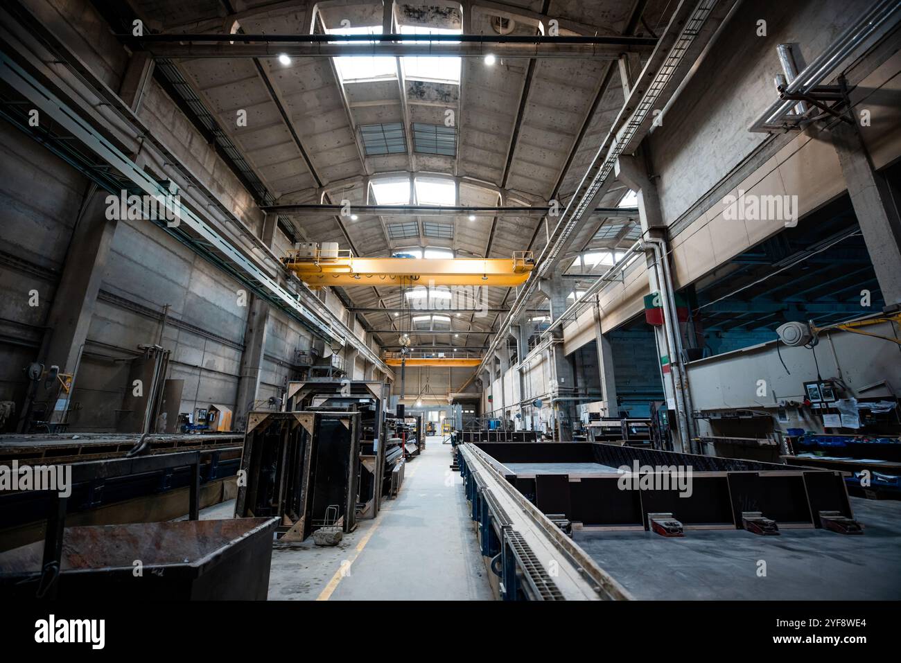 The interior of a big industrial building or factory with steel and ...