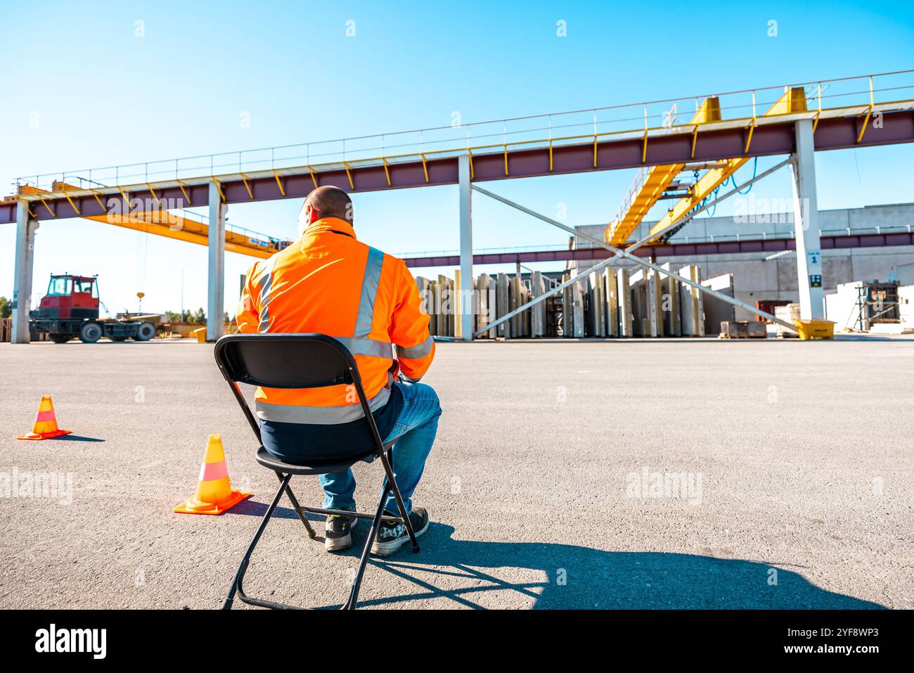 Male engineer worker in safety vest sitting, feeling tired from work ...