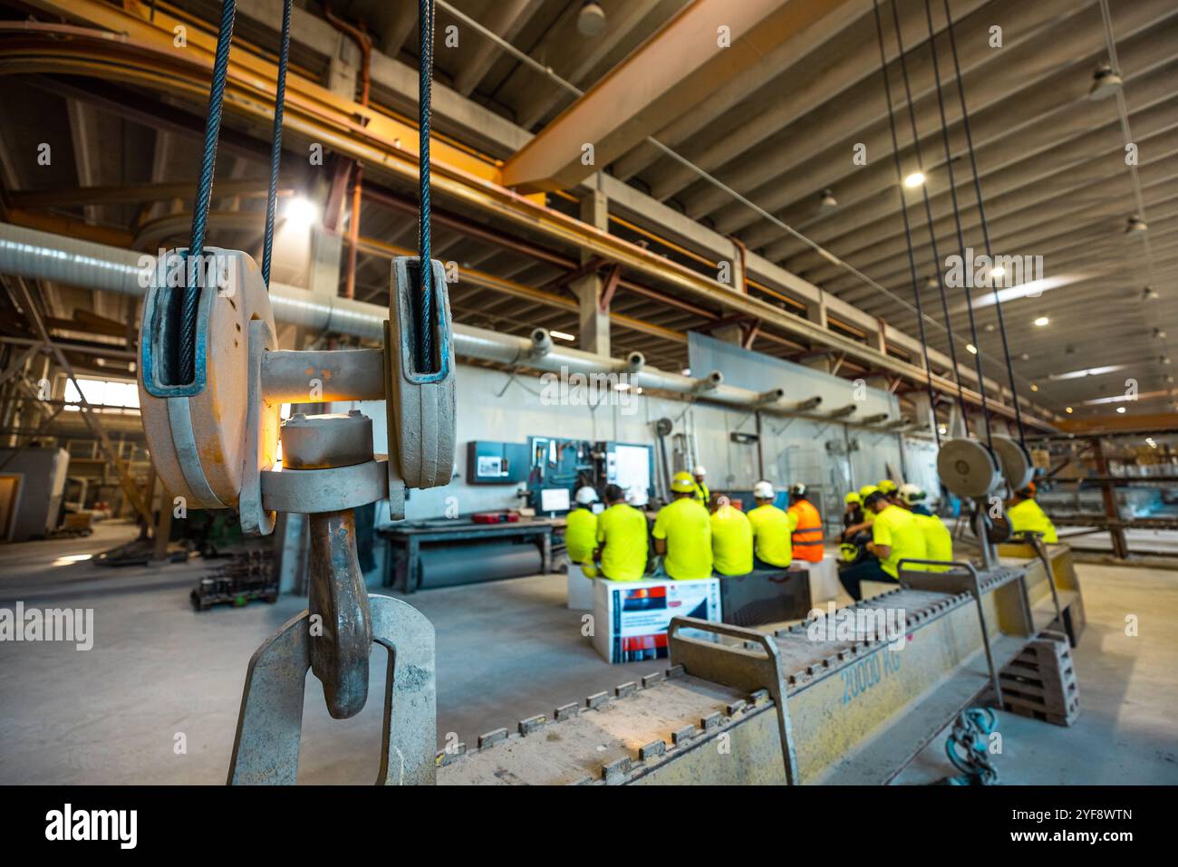 Skillful worker attending brief meeting in the factory . Industrial ...