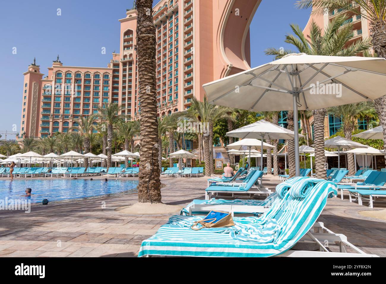 Swimming pool and sunbeds and sun loungers with parasols at the ...