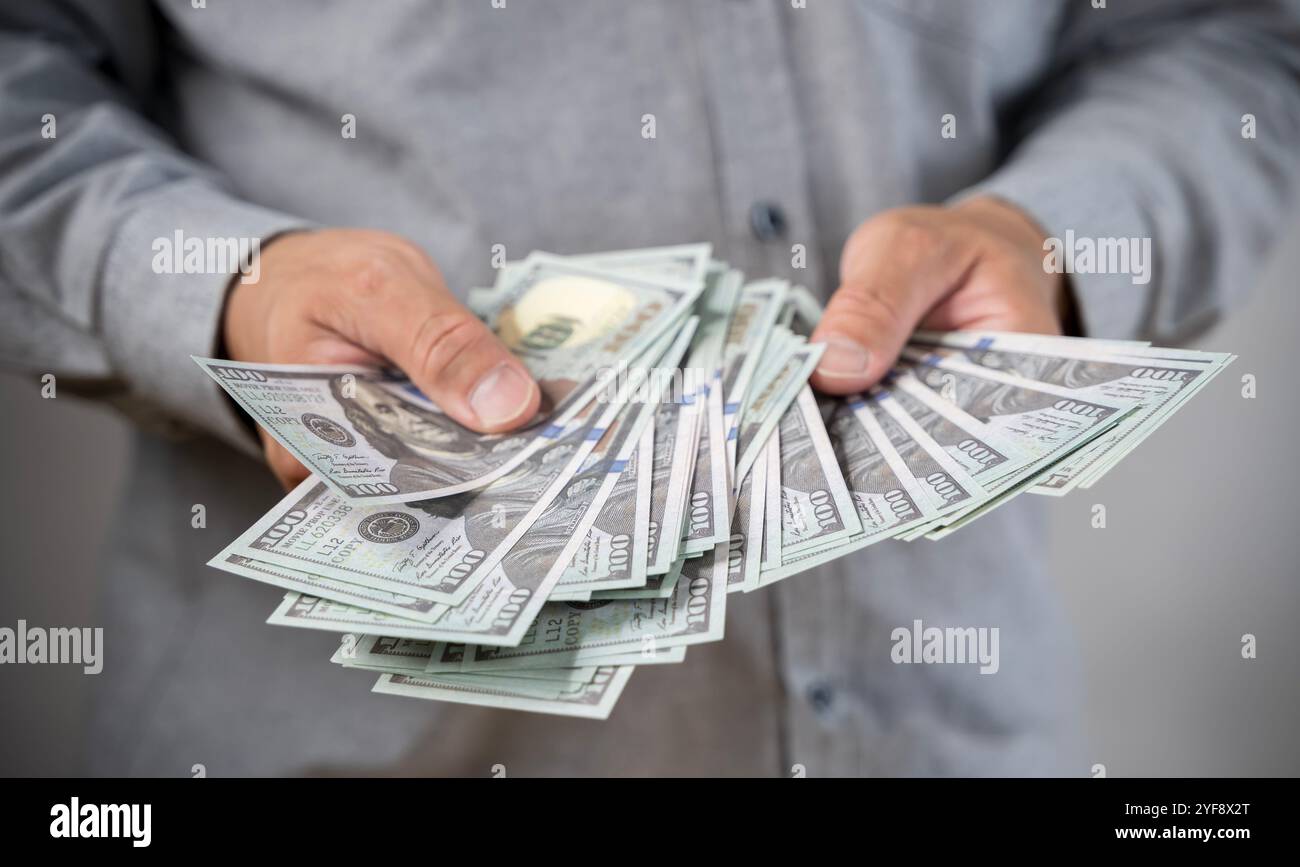 Close up of man hand holding 100 dollar bills currency. Close-up of ...