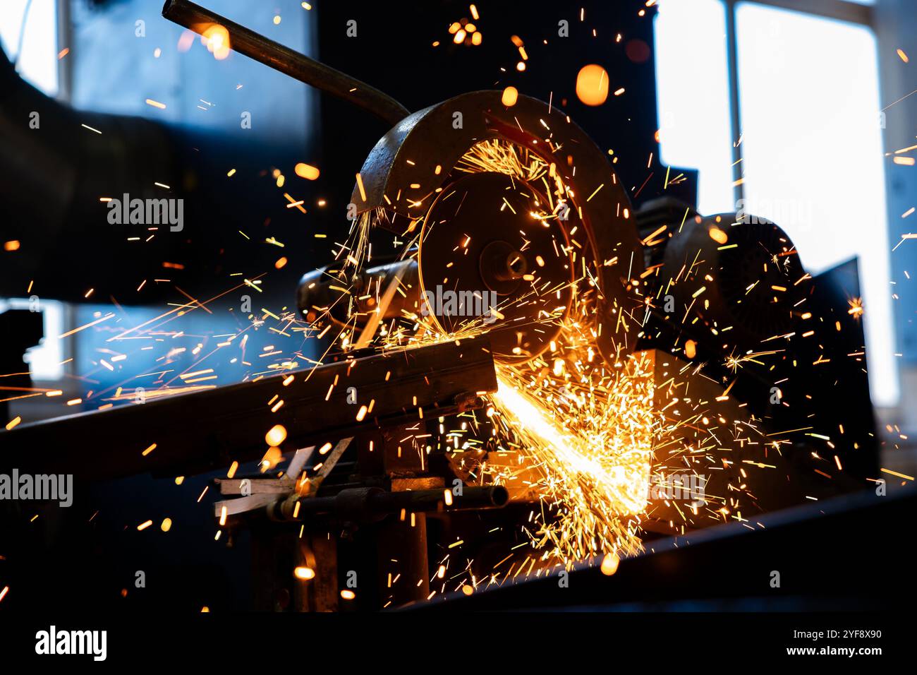 Cutting a metal using cutting machine and the fire sparks splashes ...