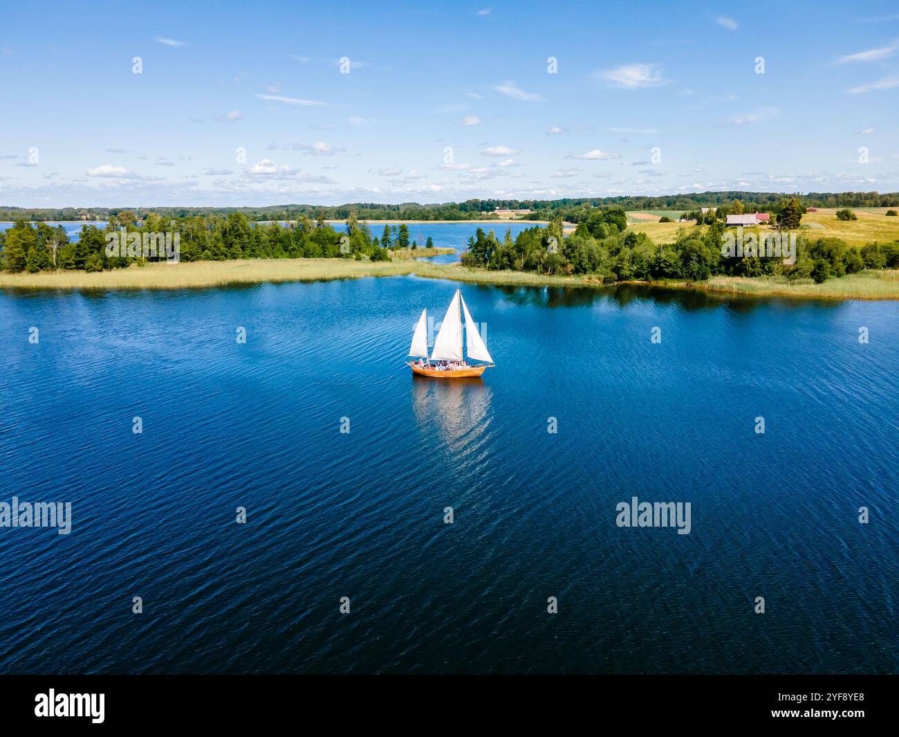 Aerial view of beautiful modern white sailing yacht sails on the sea ...