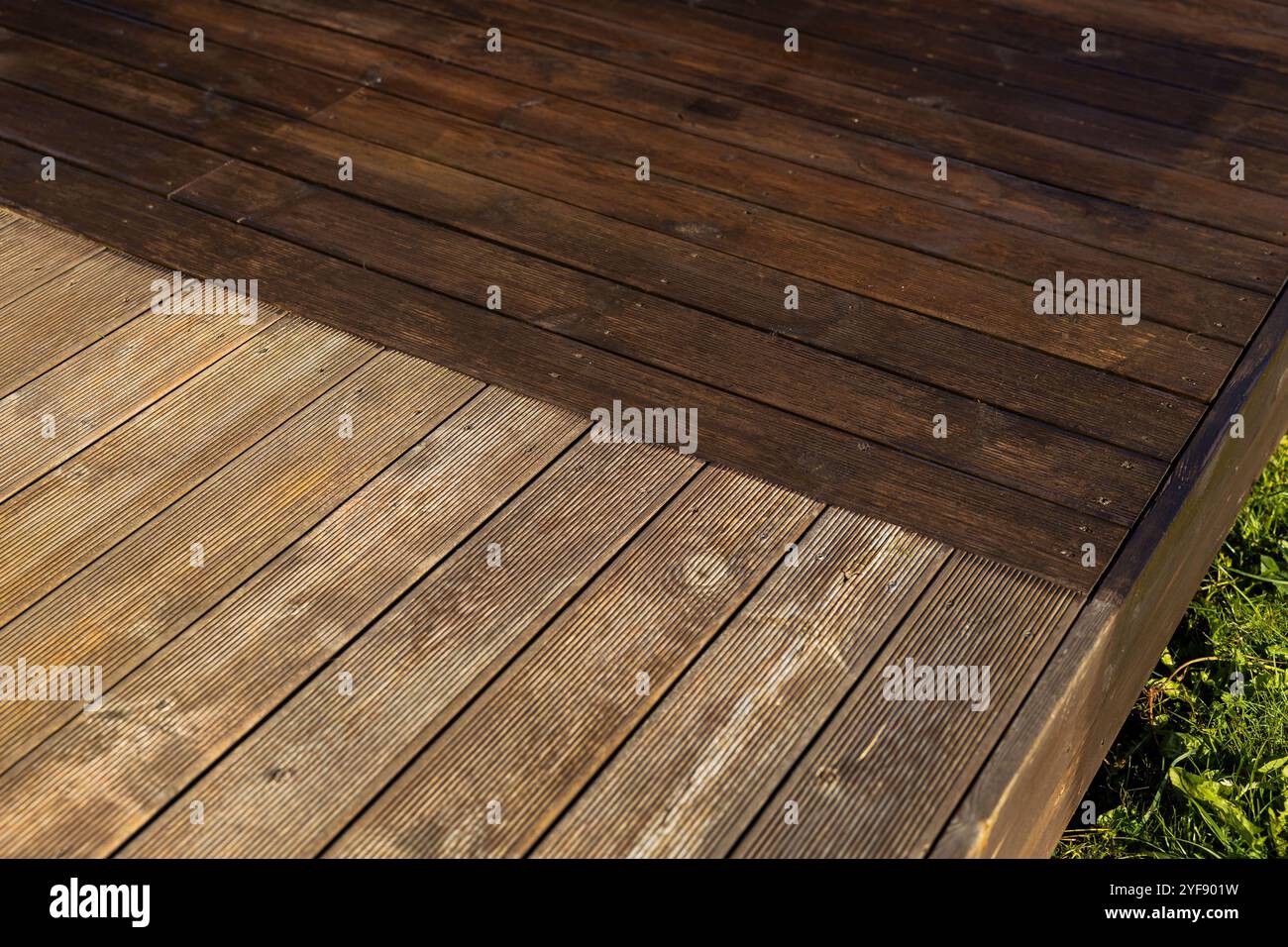Decking boards before and after painting Stock Photo - Alamy