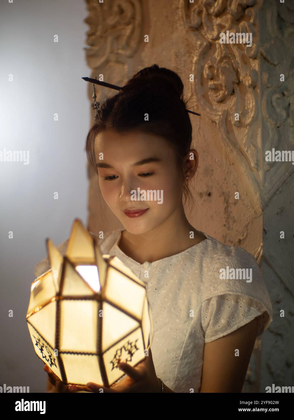 Beautiful Asian women holding a traditional paper lantern during Yi ...