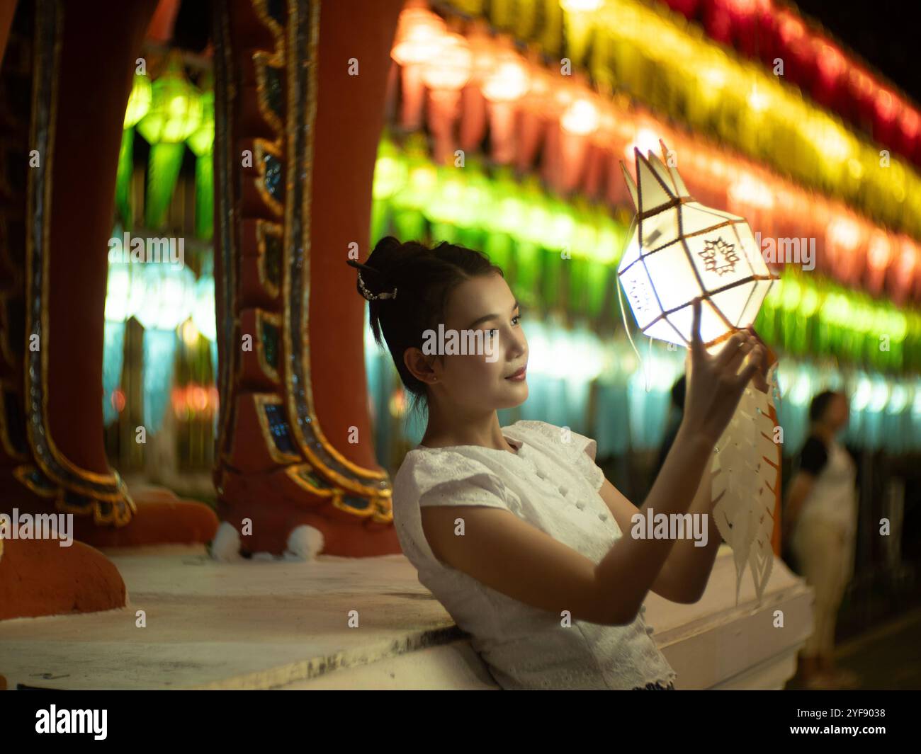 Beautiful Asian women holding a traditional paper lantern during Yi ...