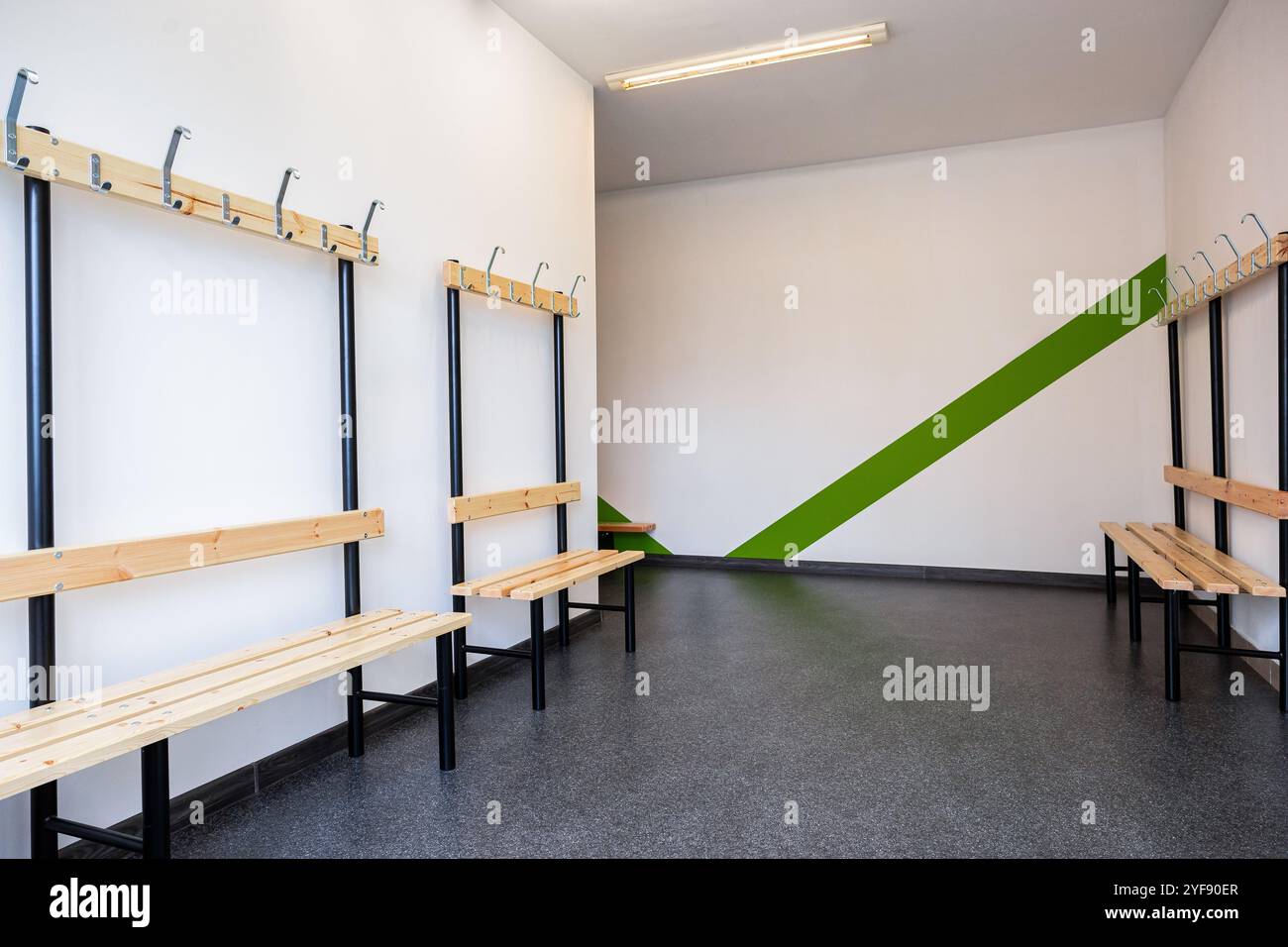 Modern Locker Room with Vibrant Green and White Striped Walls, Wooden ...