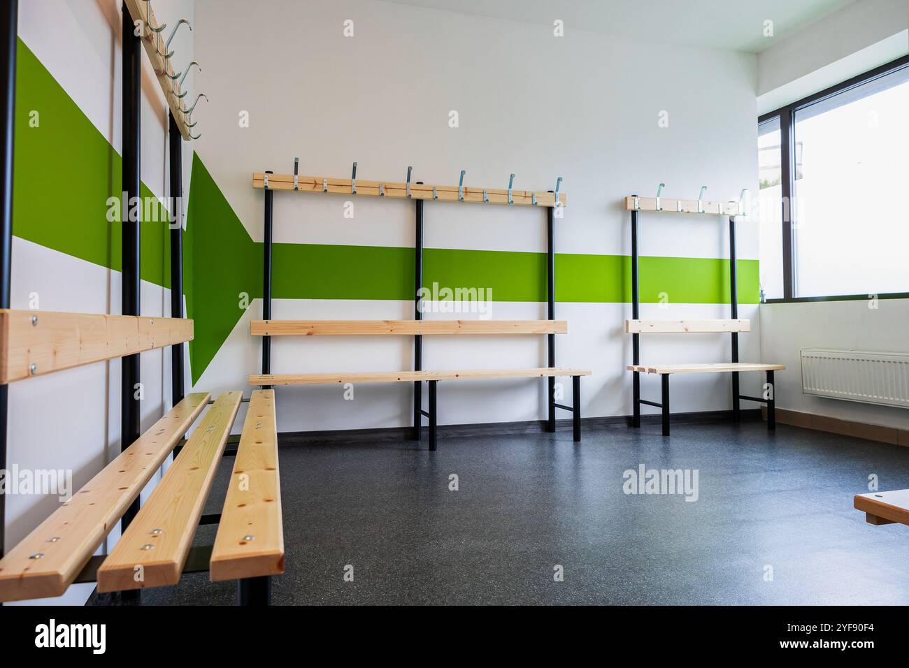 Modern Locker Room with Vibrant Green and White Striped Walls, Wooden ...