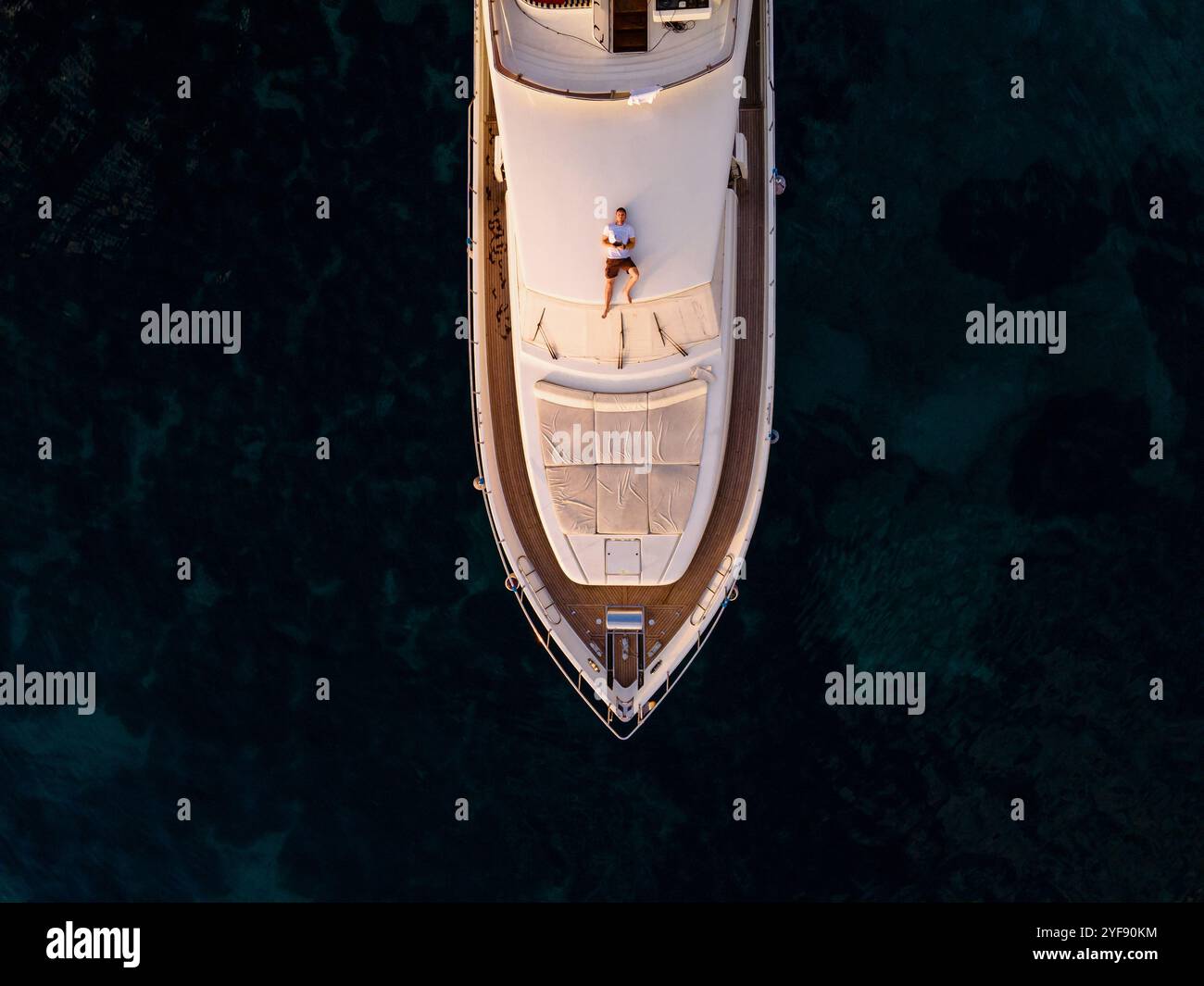 Serene Aerial View of Man Contemplating the Ocean on a Private Yacht ...