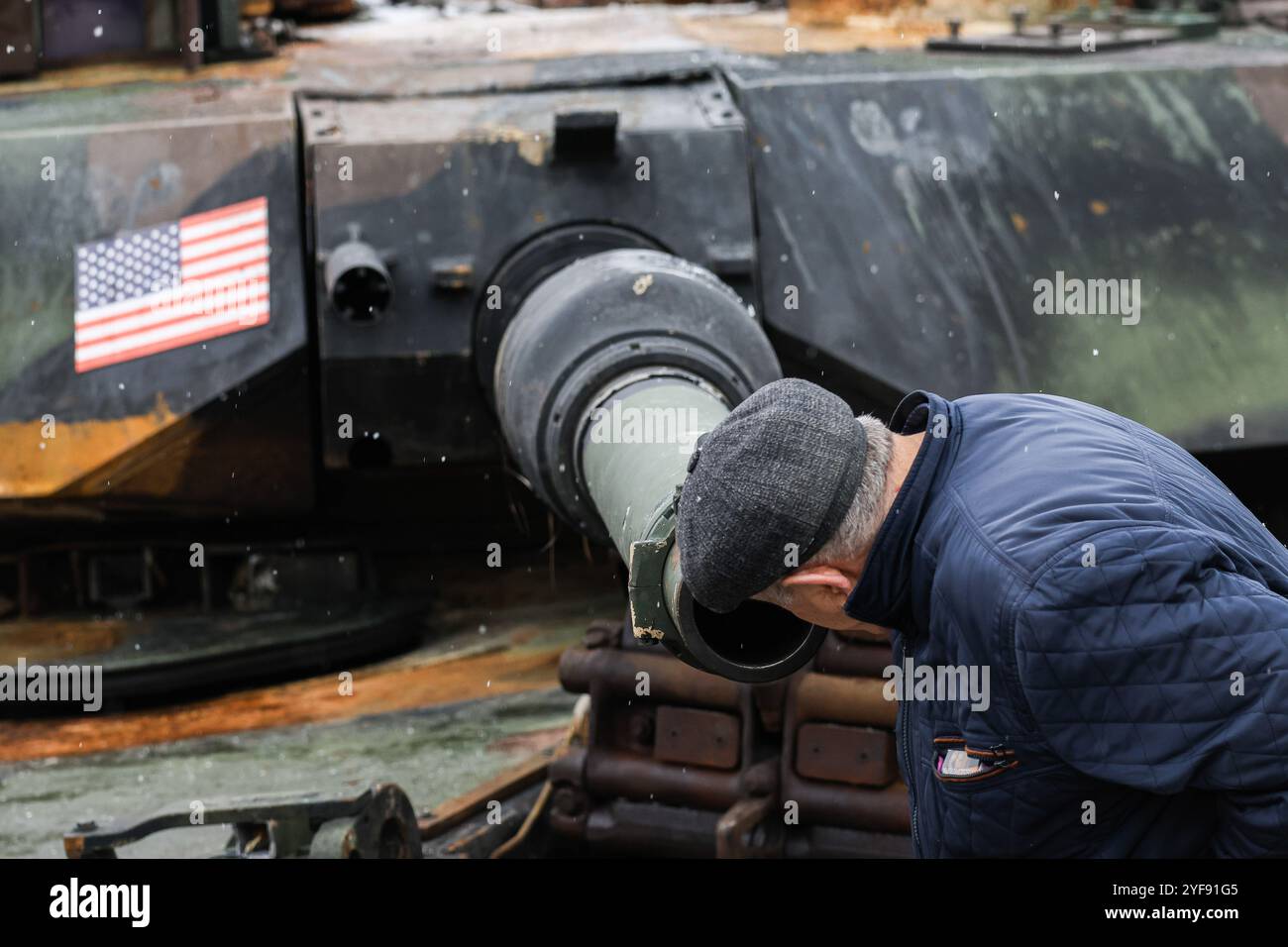 A man looks down the barrel of a US-made M1 Abrams battle tank captured ...
