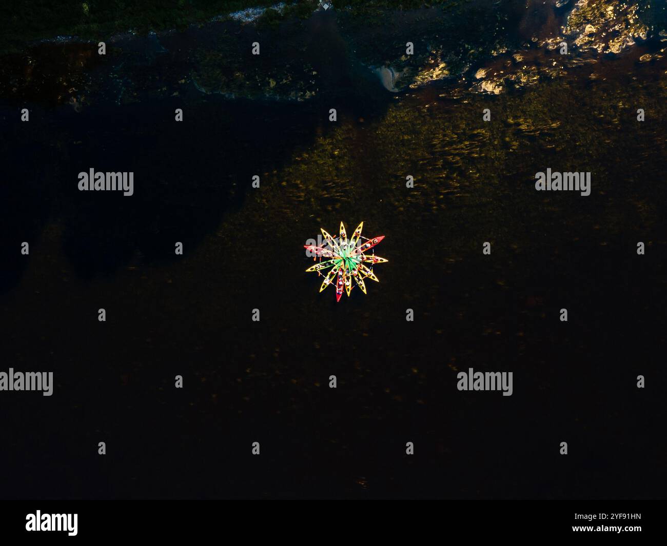 Spectacular aerial view of kayaks forming a star pattern form on a ...