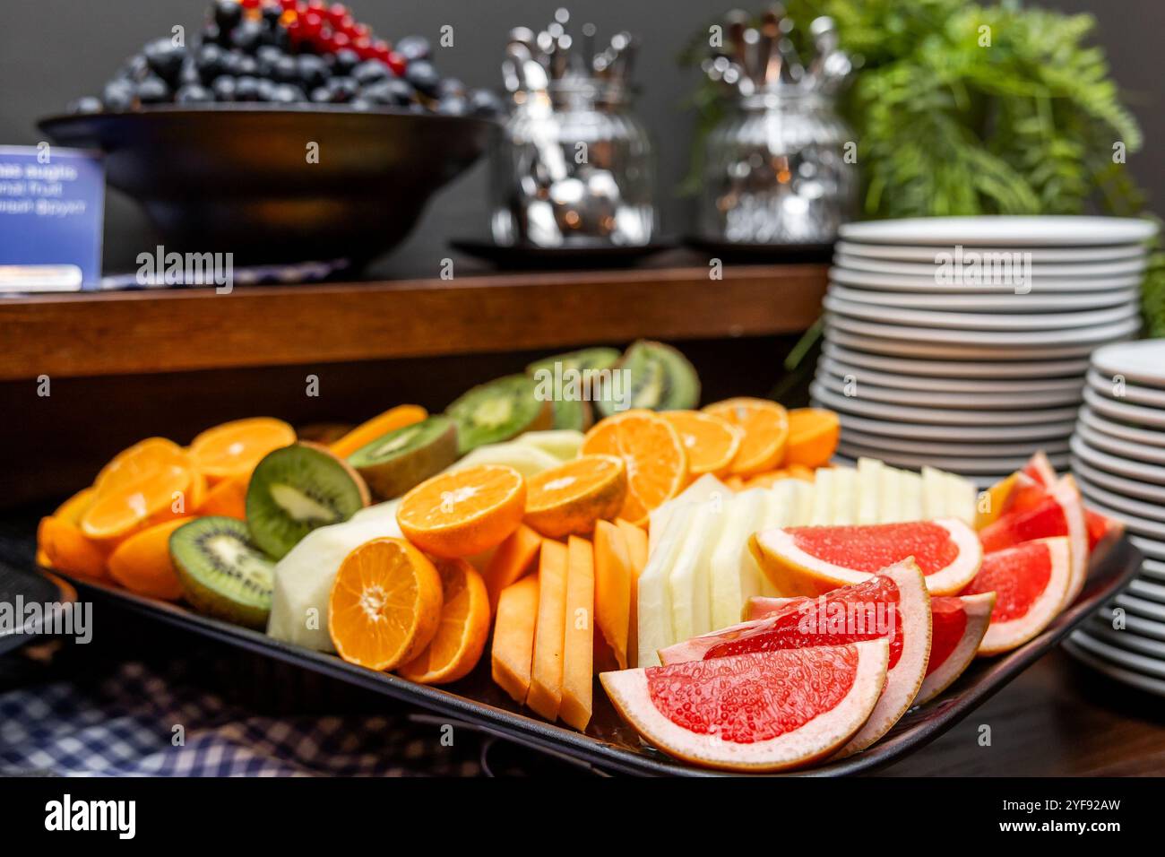 Assorted Fresh Fruits Display on a Buffet with Desserts and Utensils, Elegant Catering Concept ...