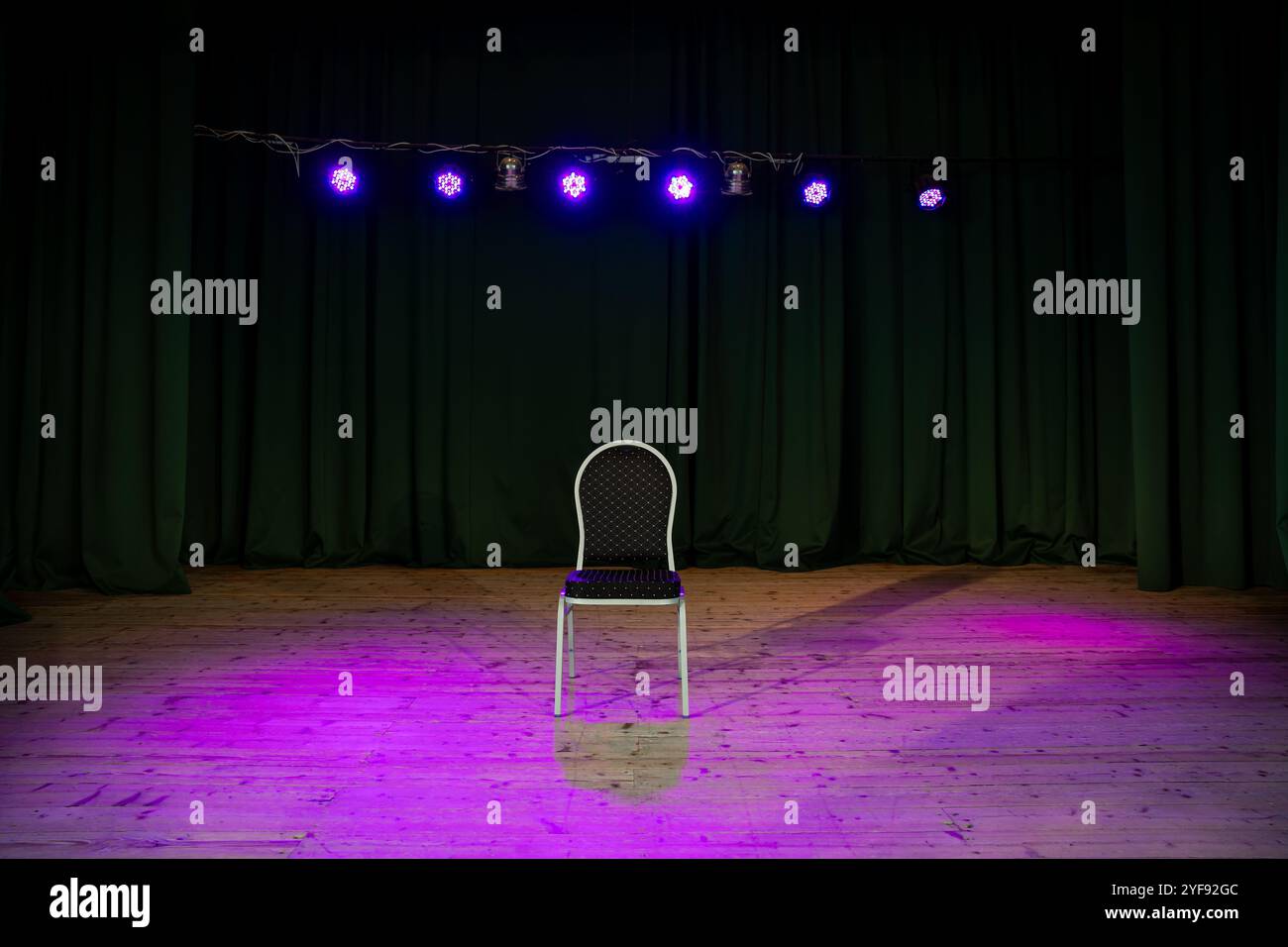 Empty theater stage bathed in hi-res stock photography and images - Alamy