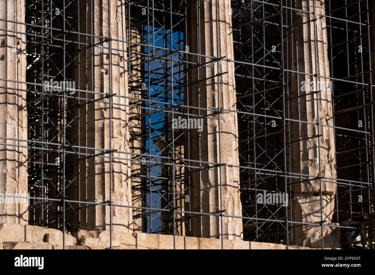 The Parthenon temple under renovation construction with crane and scaffolding on the Acropolis ...