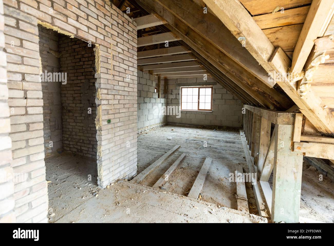 Abandoned building interior in disrepair with debris, exposed pipes, and missing doors awaiting ...