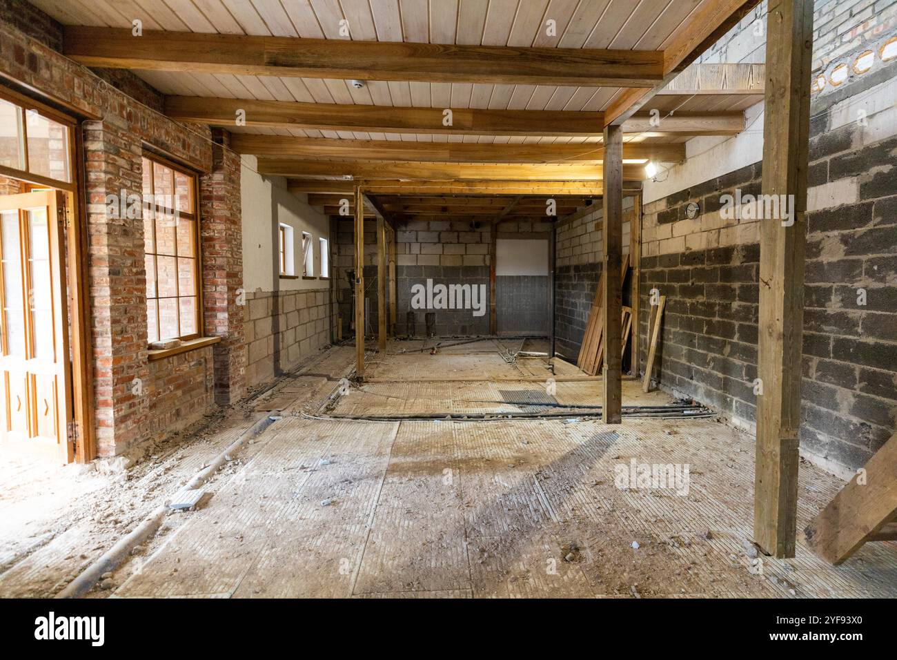 Abandoned building interior in disrepair with debris, exposed pipes ...