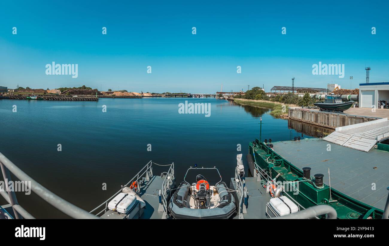 View from a Military Patrol Boat Navigating River with Industrial Port ...