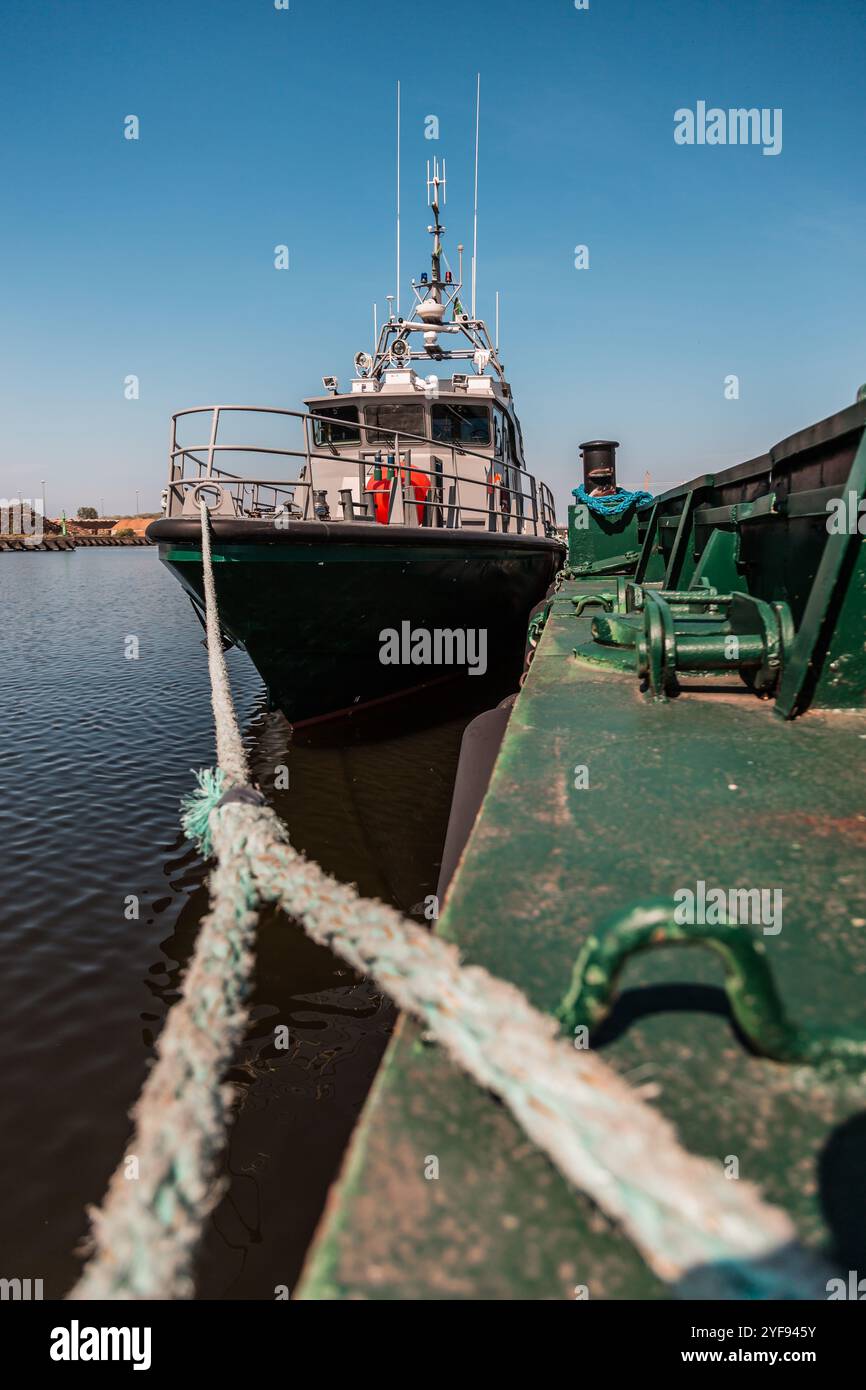 Strategic military vessel moored at dock showcasing advanced naval ...
