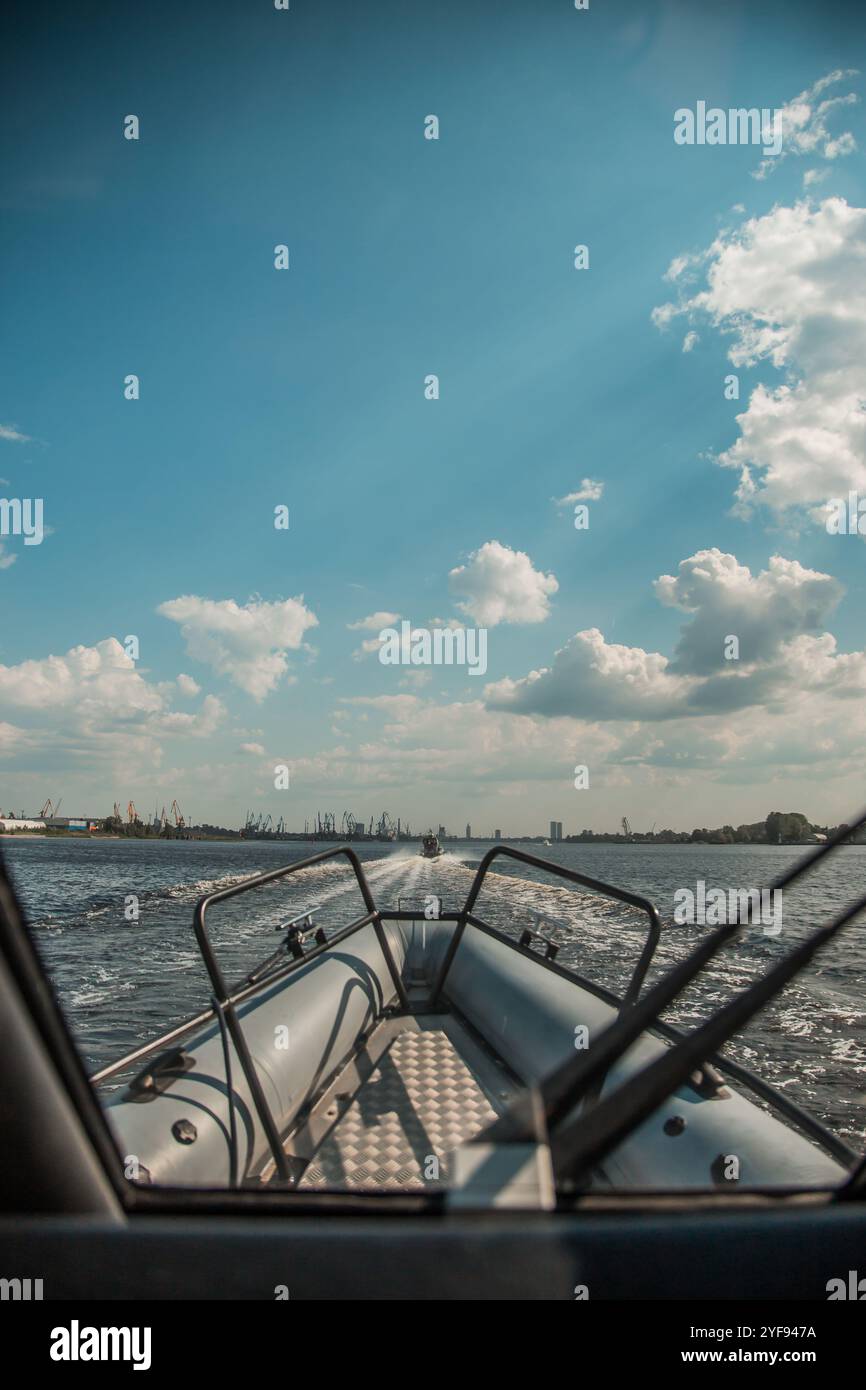 View from a Military Patrol Boat Navigating River with Industrial Port ...