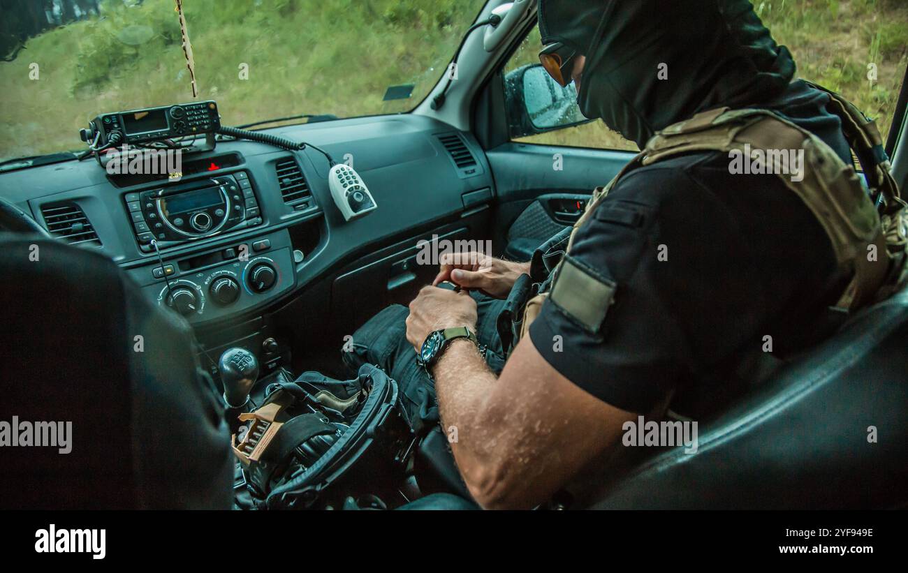 tactical professional ready in a vehicle with communications equipment ...