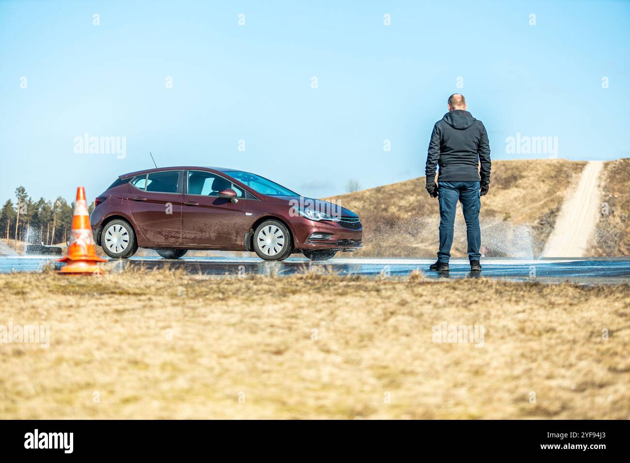 dynamic car braking test on wet road surface with water splashes and ...