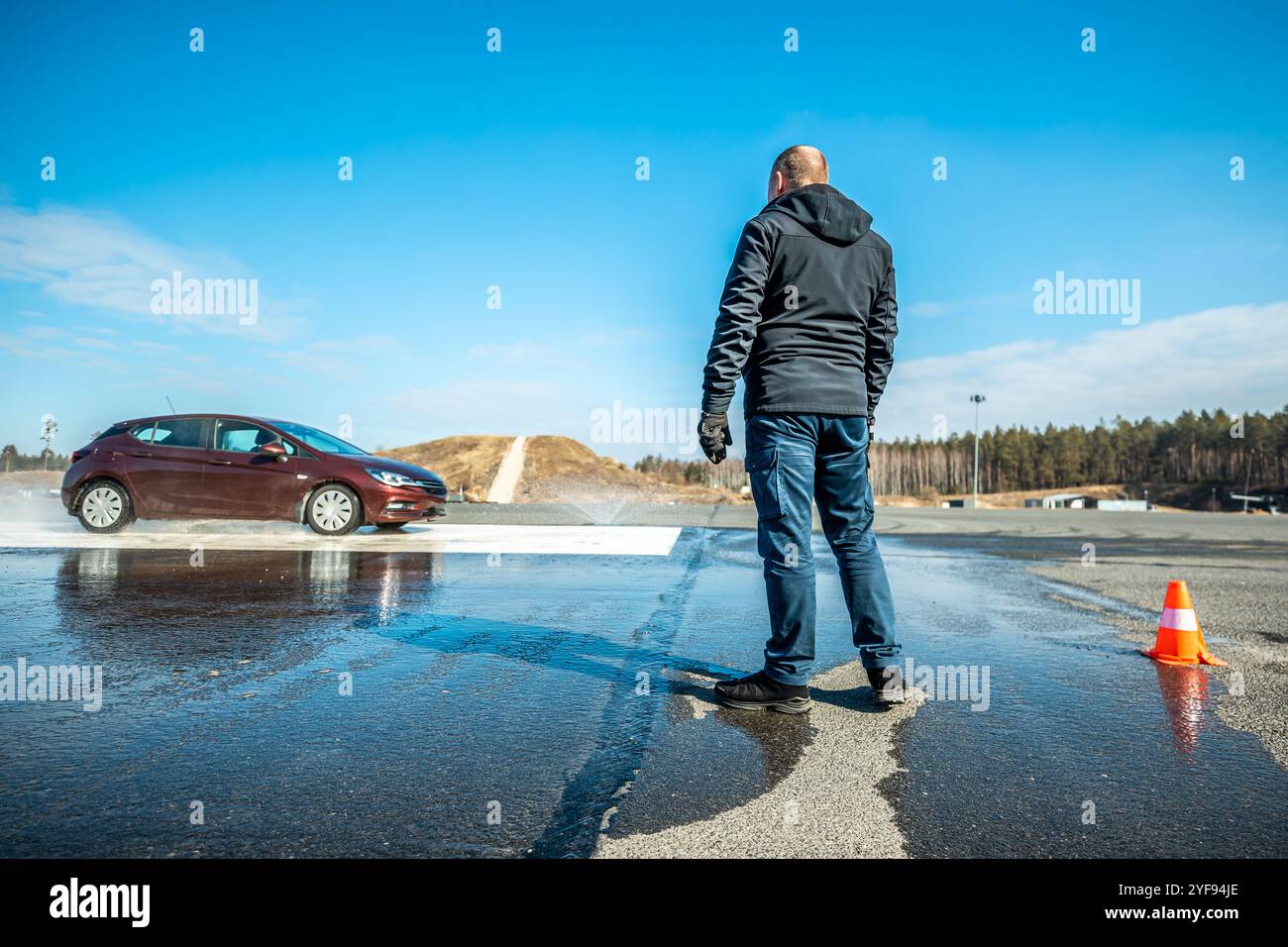 dynamic car braking test on wet road surface with water splashes and ...