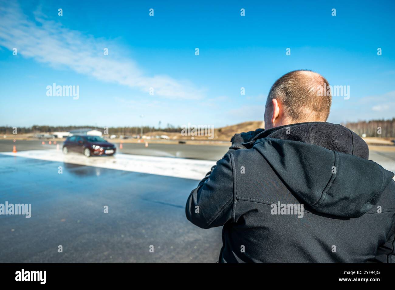 dynamic car braking test on wet road surface with water splashes and ...
