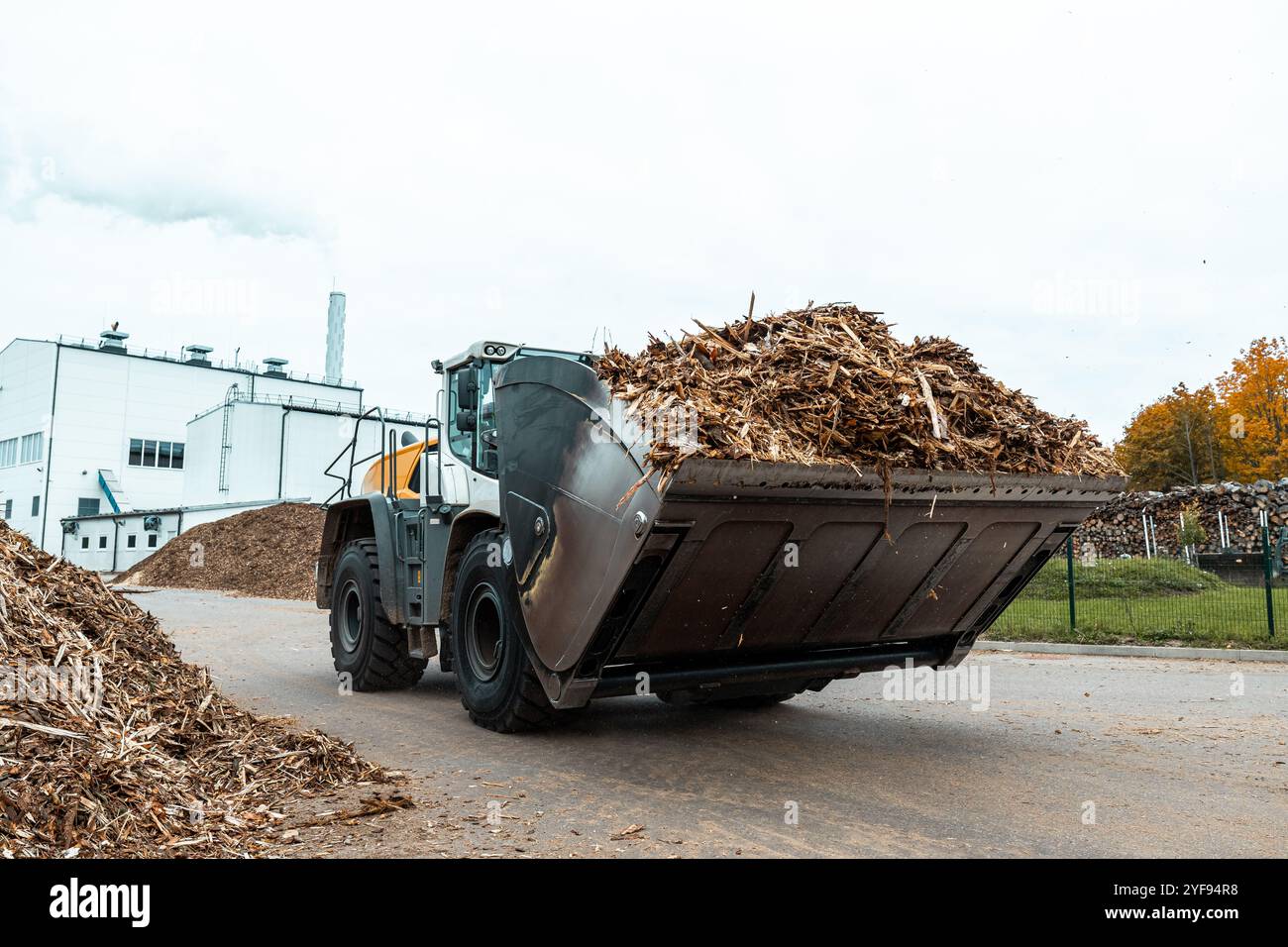 industrial wheel loader with raised bucket at a biomass power plant ...