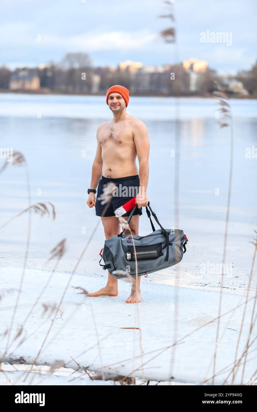 winter swimming enthusiast prepares for a chilly dip in the river ...