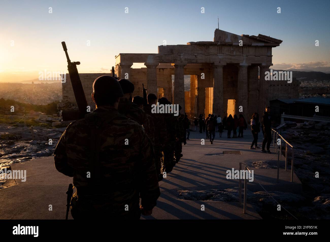 Soldier from the Greek army taking down the Greek flag at sunset close ...