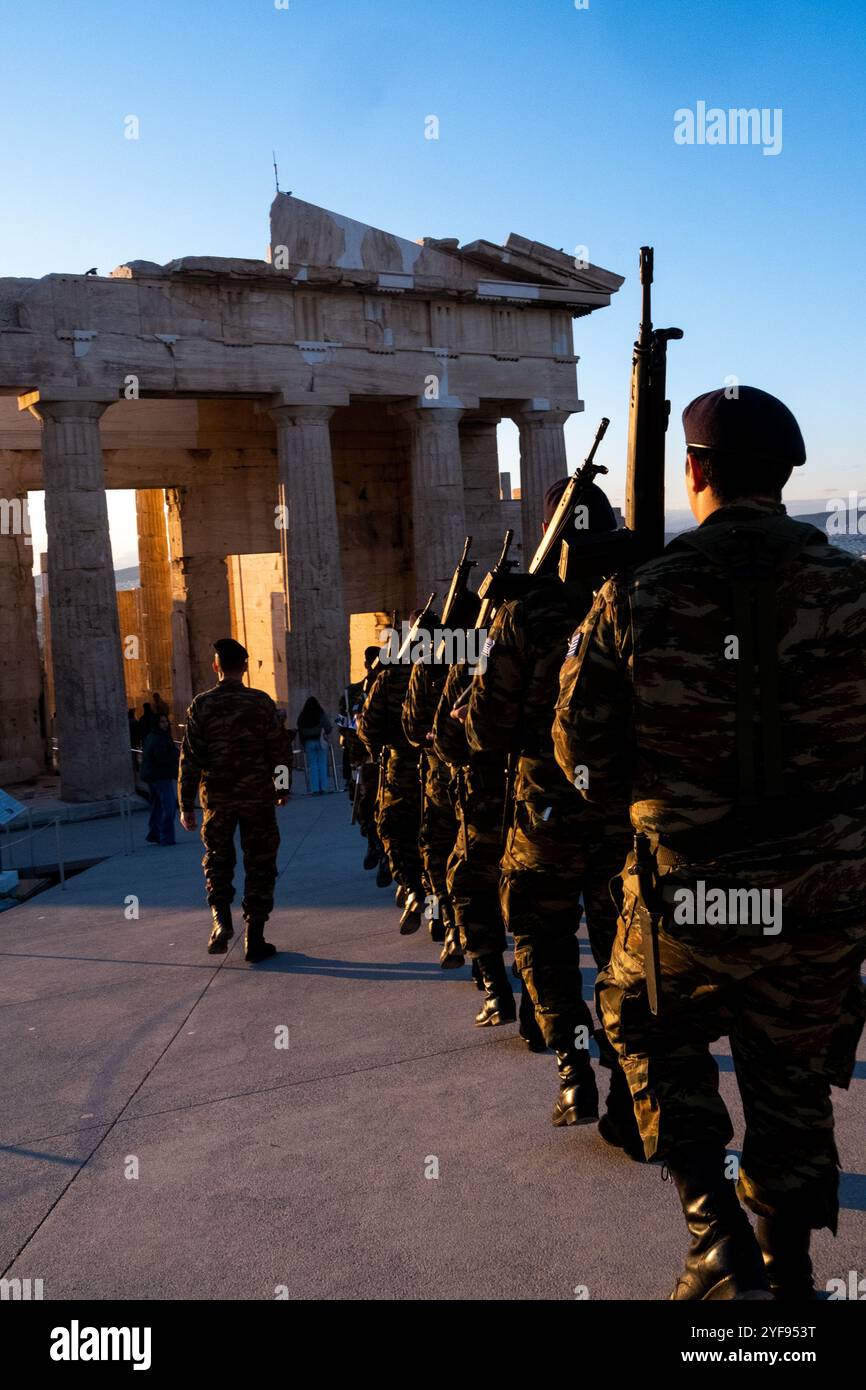 Soldier from the Greek army taking down the Greek flag at sunset close ...