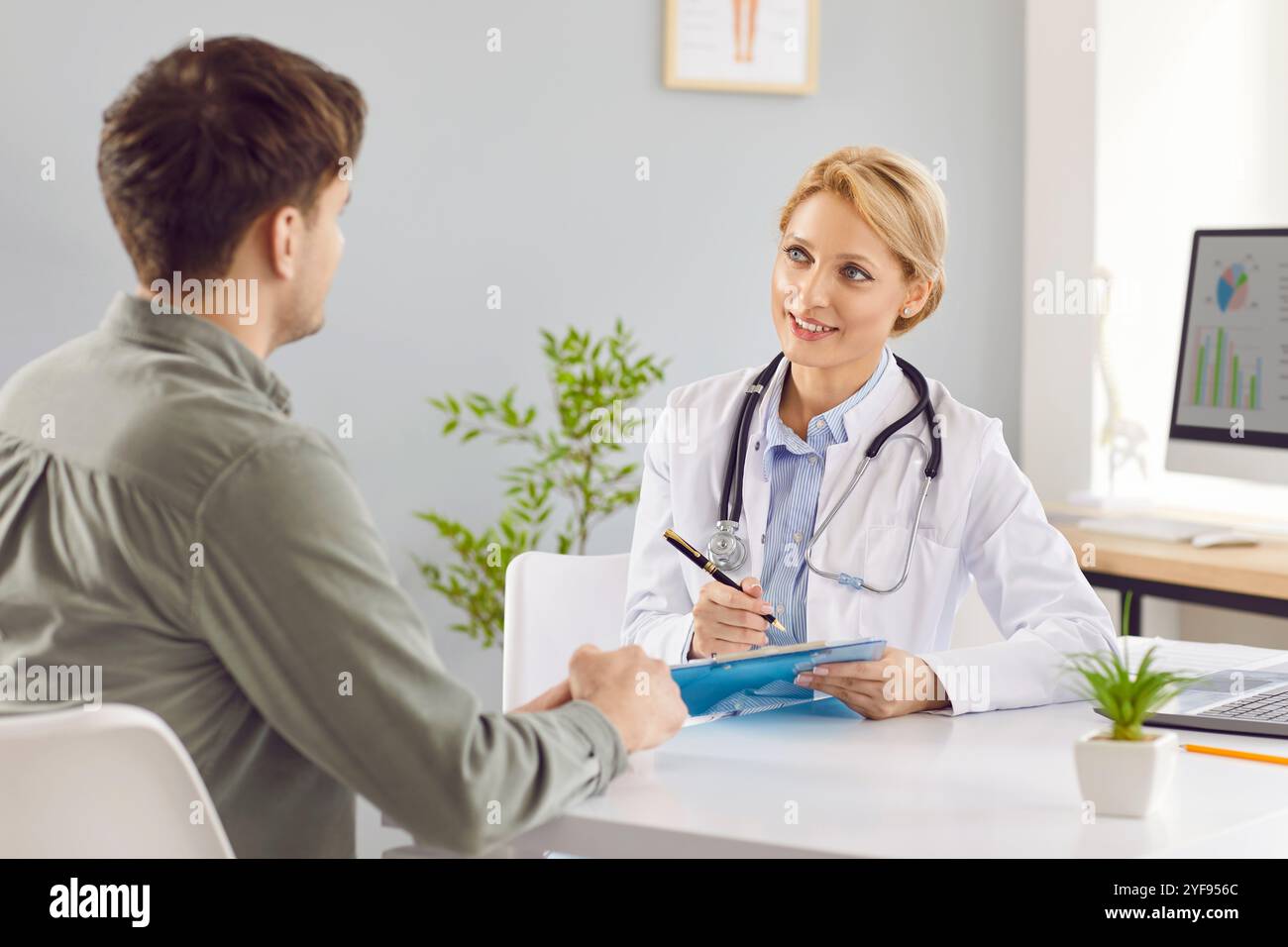 Positive Doctor Or Nurse Talking To Patient During Hospital Visit Stock ...