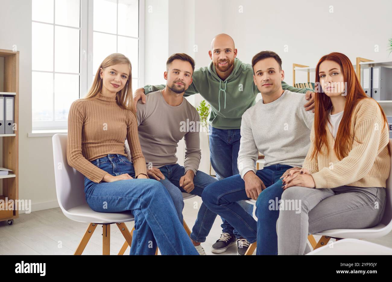 Group portrait of people, friends gathered together sitting close for ...