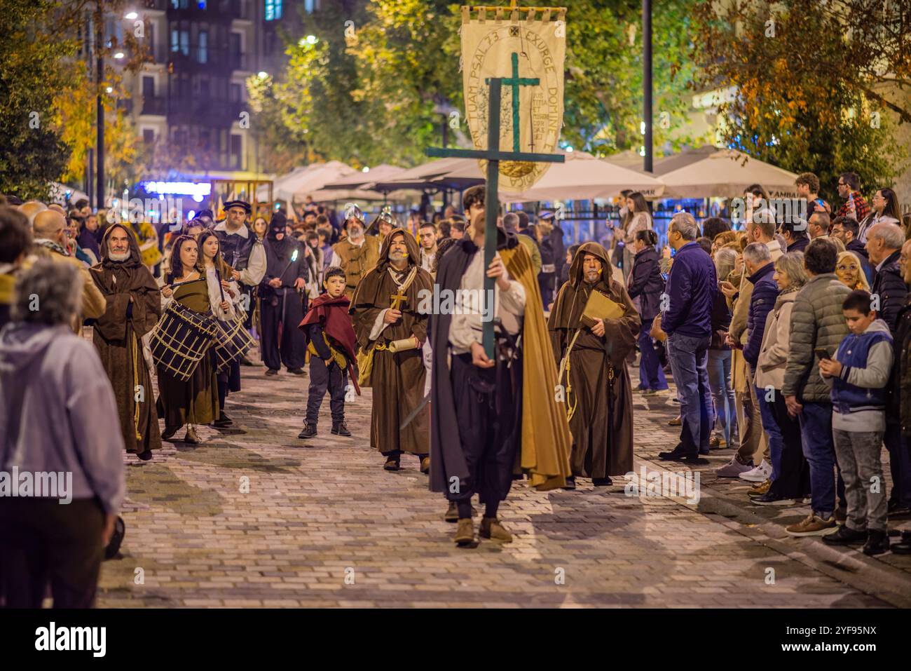 Actor characterized with pale makeup and costumes with flames in night ...