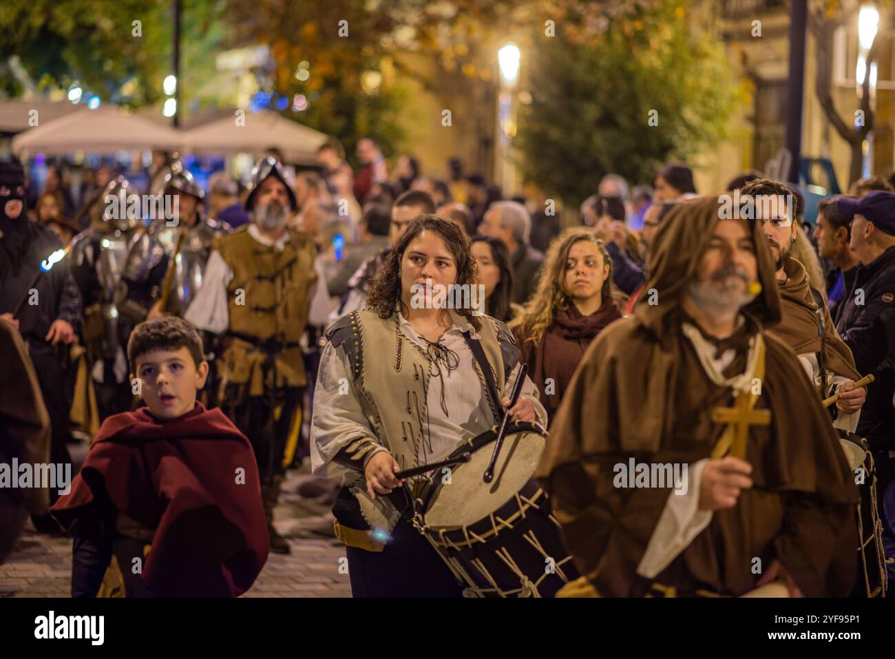 Actor characterized with pale makeup and costumes with flames in night ...