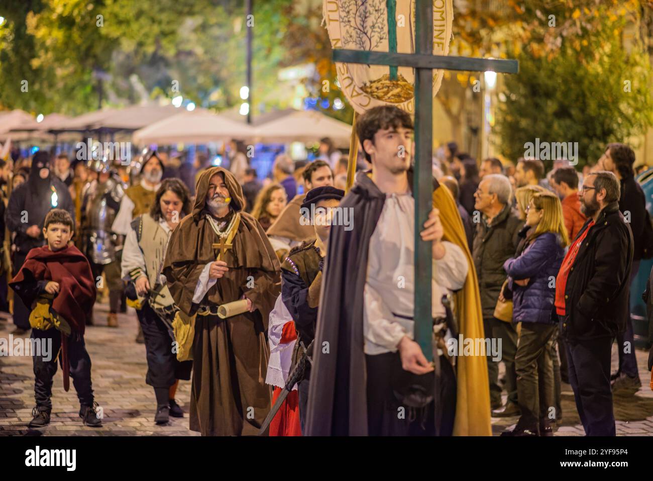 Actor characterized with pale makeup and costumes with flames in night ...