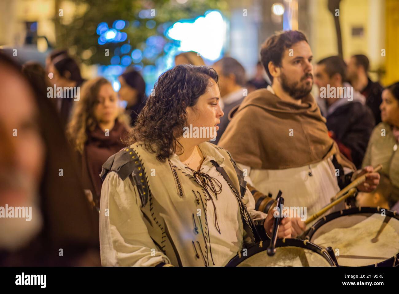 Actor characterized with pale makeup and costumes with flames in night ...