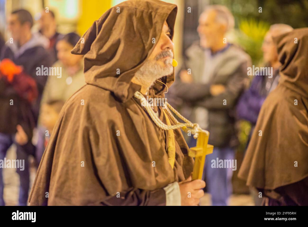 Actor characterized with pale makeup and costumes with flames in night ...