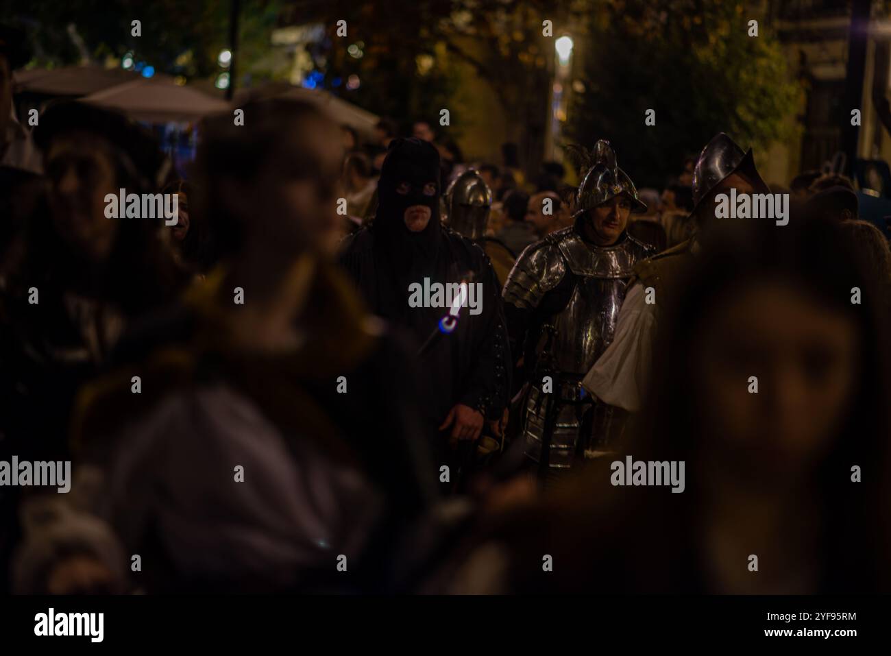 Actor characterized with pale makeup and costumes with flames in night ...