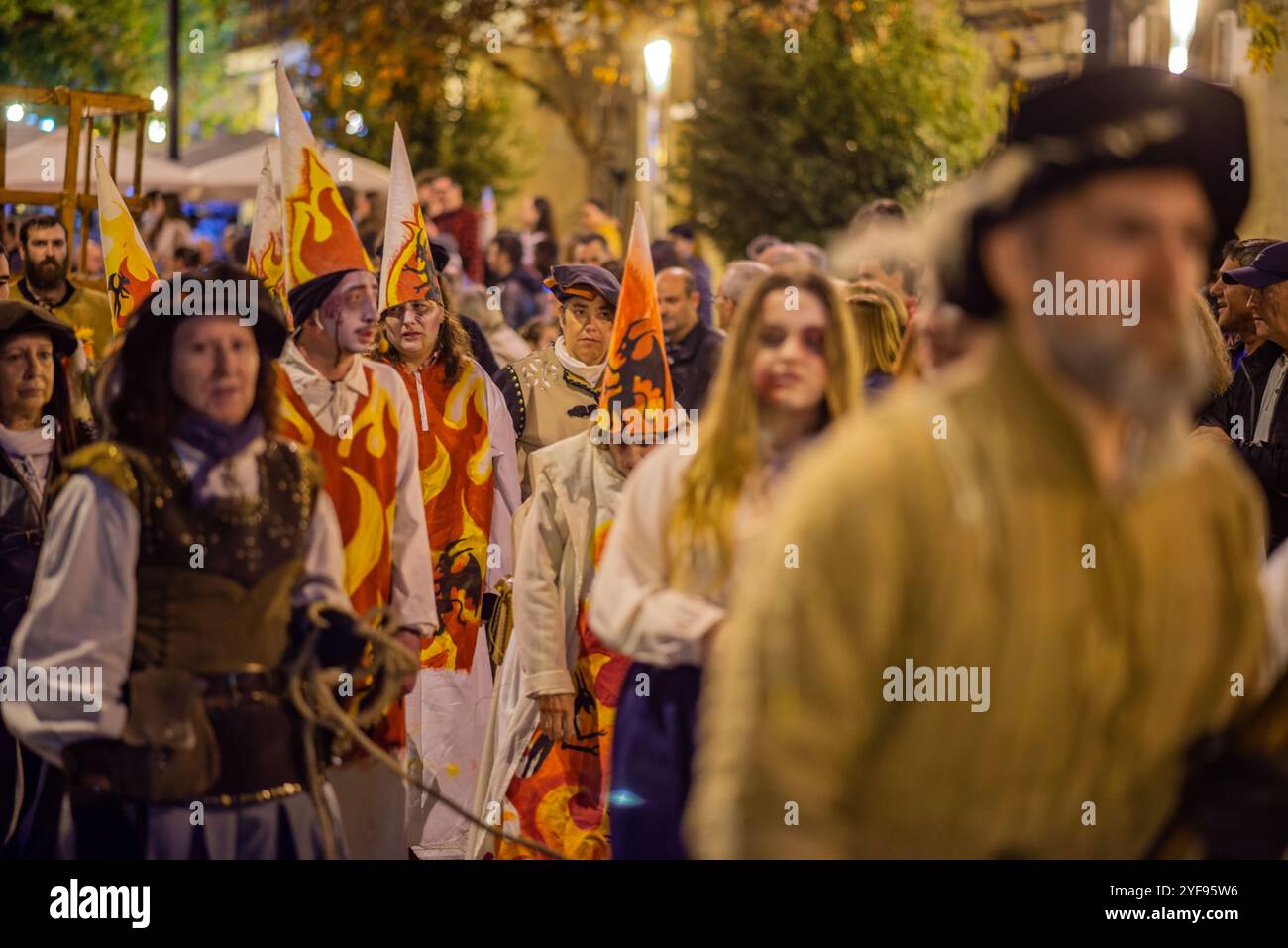 Actor characterized with pale makeup and costumes with flames in night ...