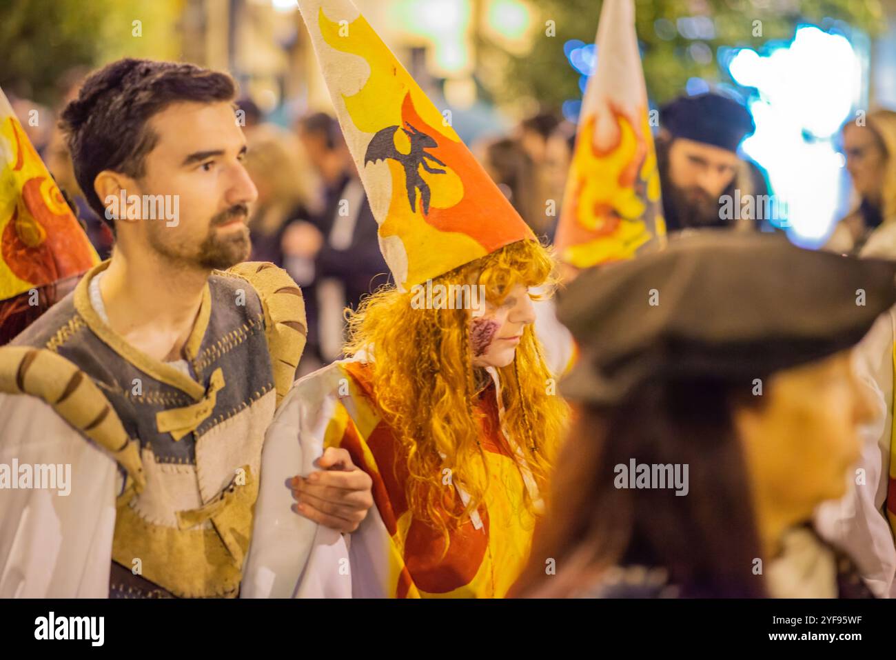 Actor characterized with pale makeup and costumes with flames in night ...