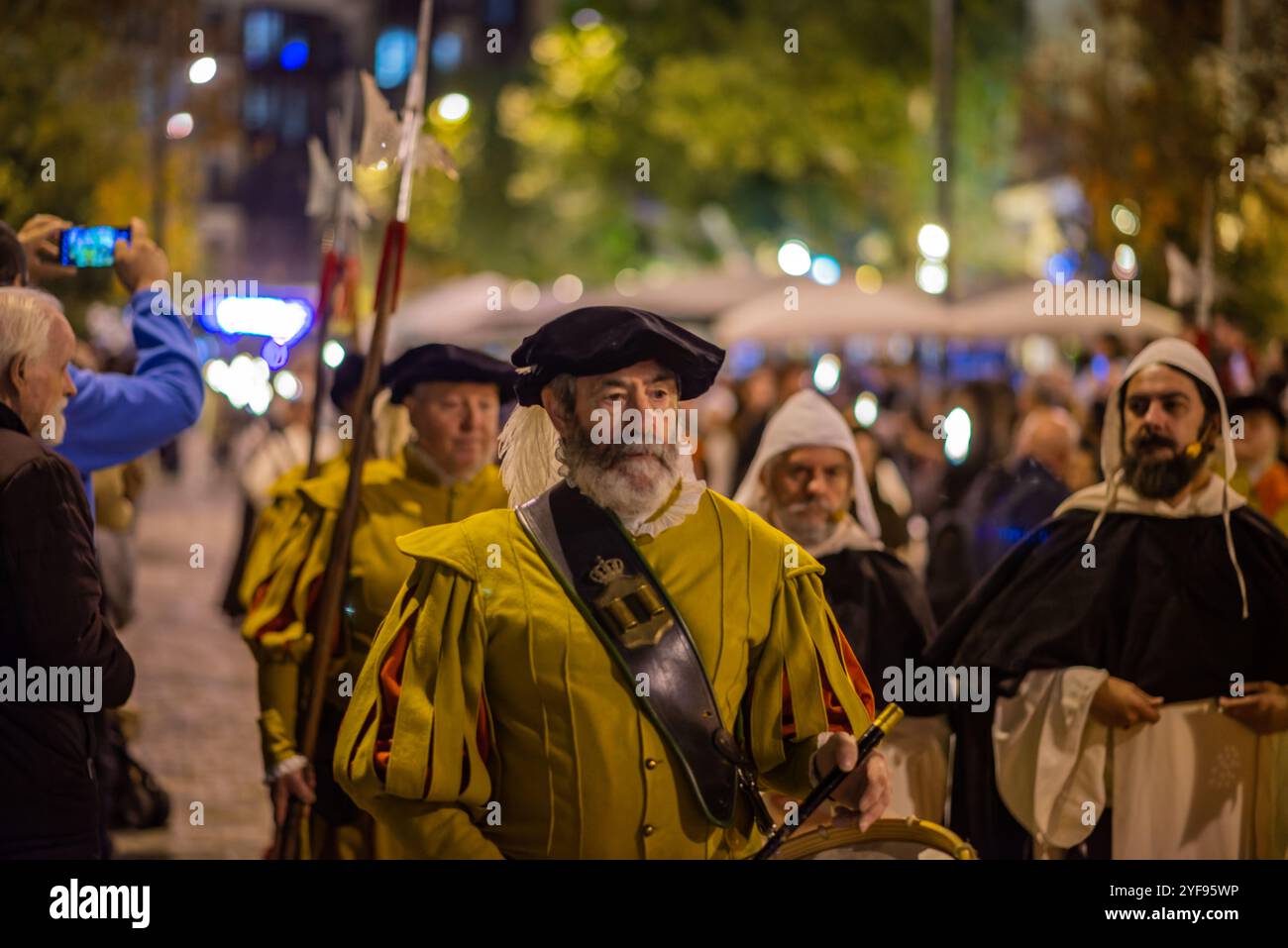 Actor characterized with pale makeup and costumes with flames in night ...