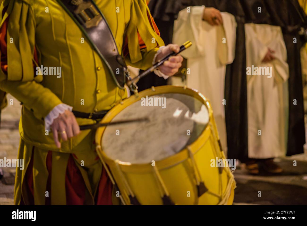 Actor characterized with pale makeup and costumes with flames in night ...