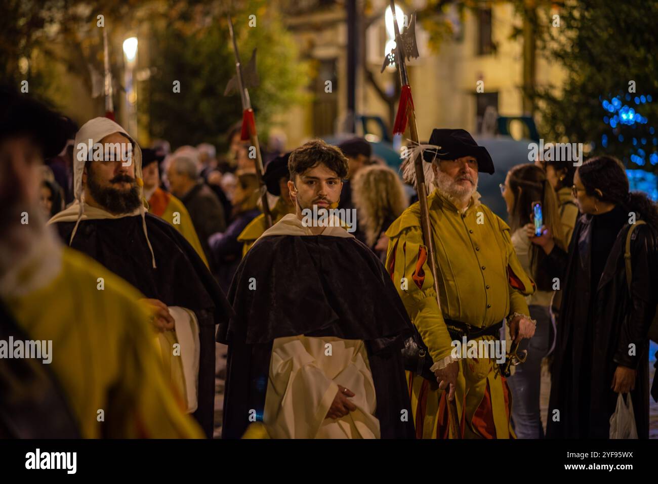 Actor characterized with pale makeup and costumes with flames in night ...