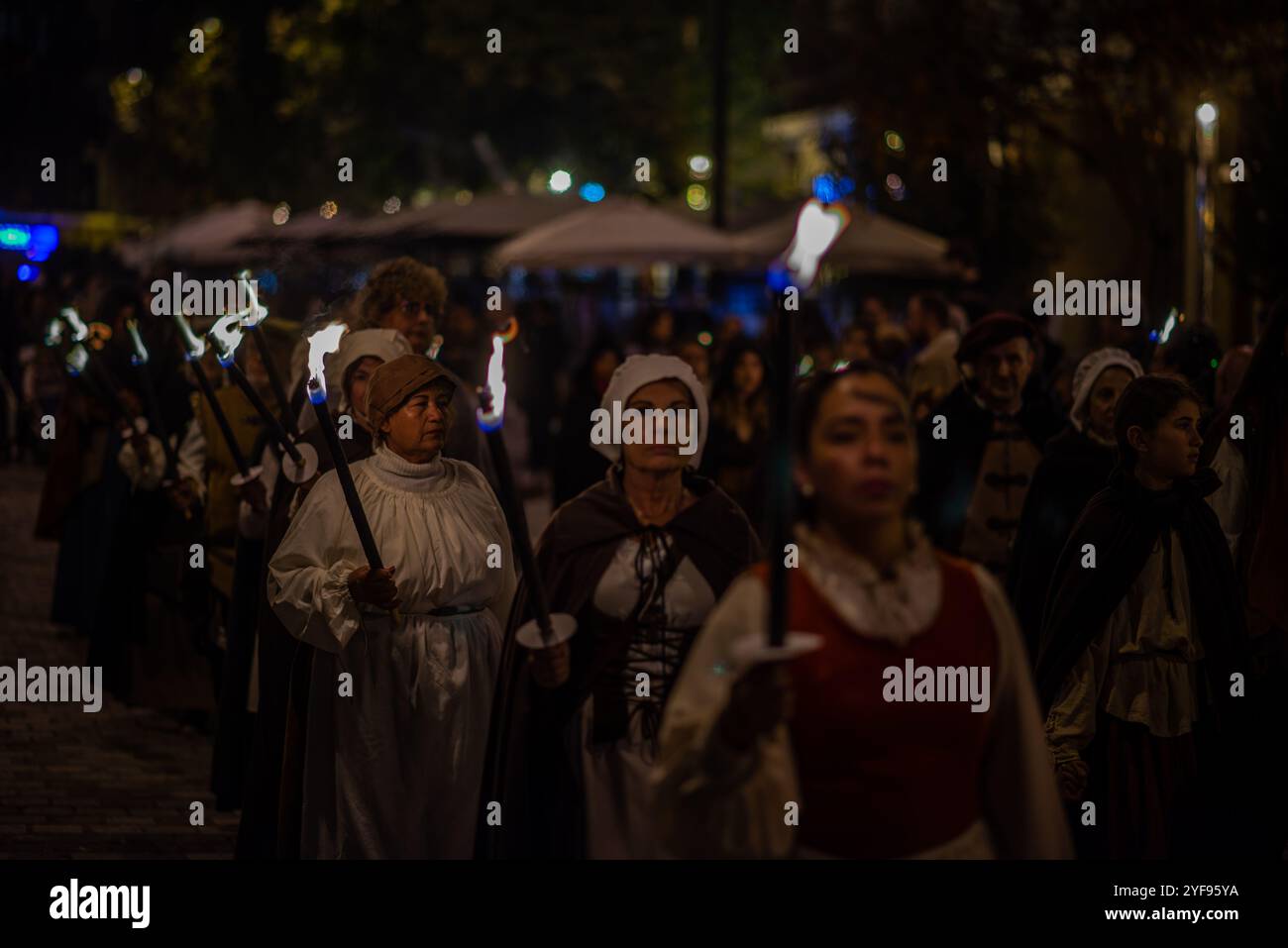Actor characterized with pale makeup and costumes with flames in night ...