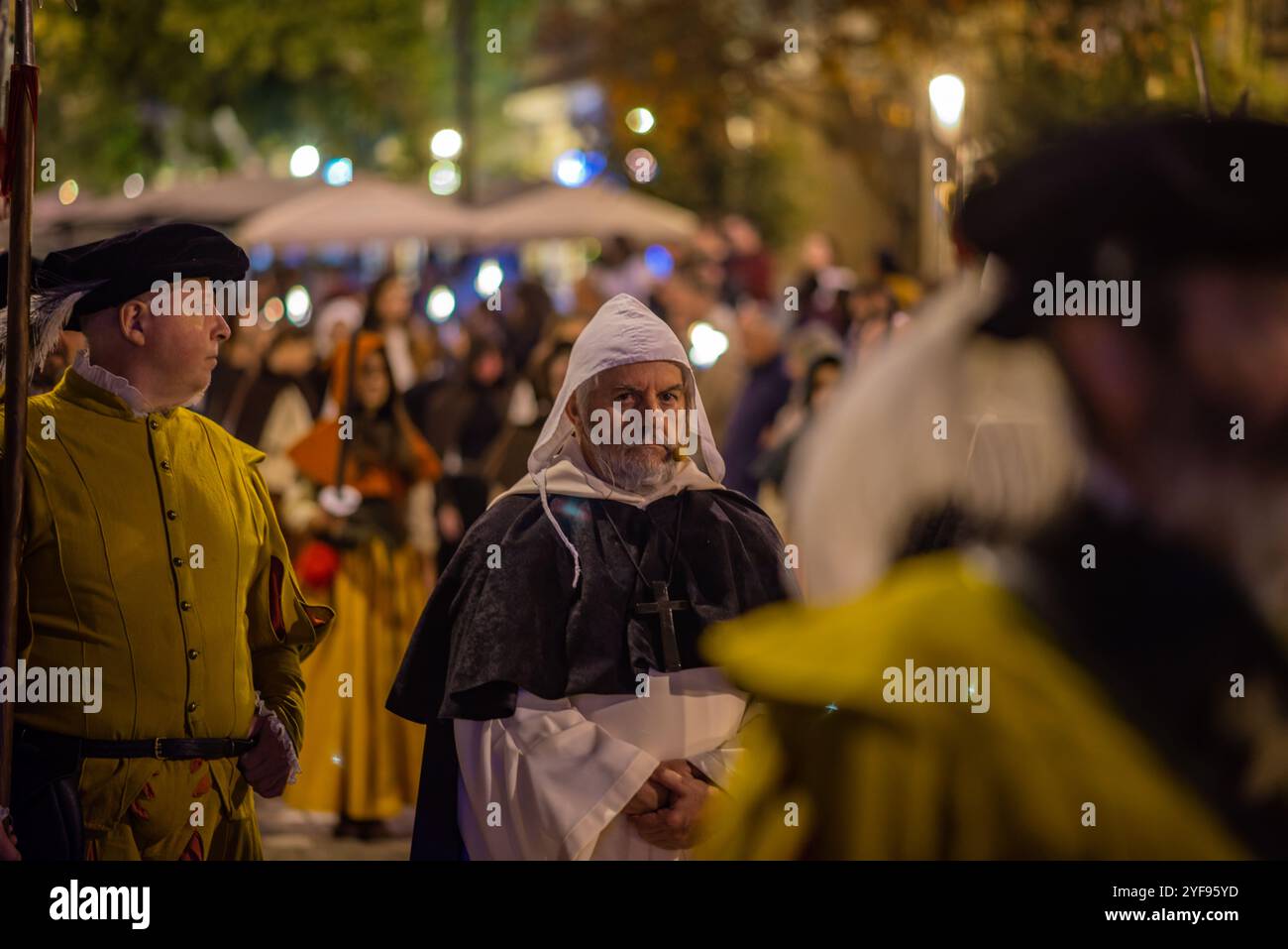 Actor characterized with pale makeup and costumes with flames in night ...
