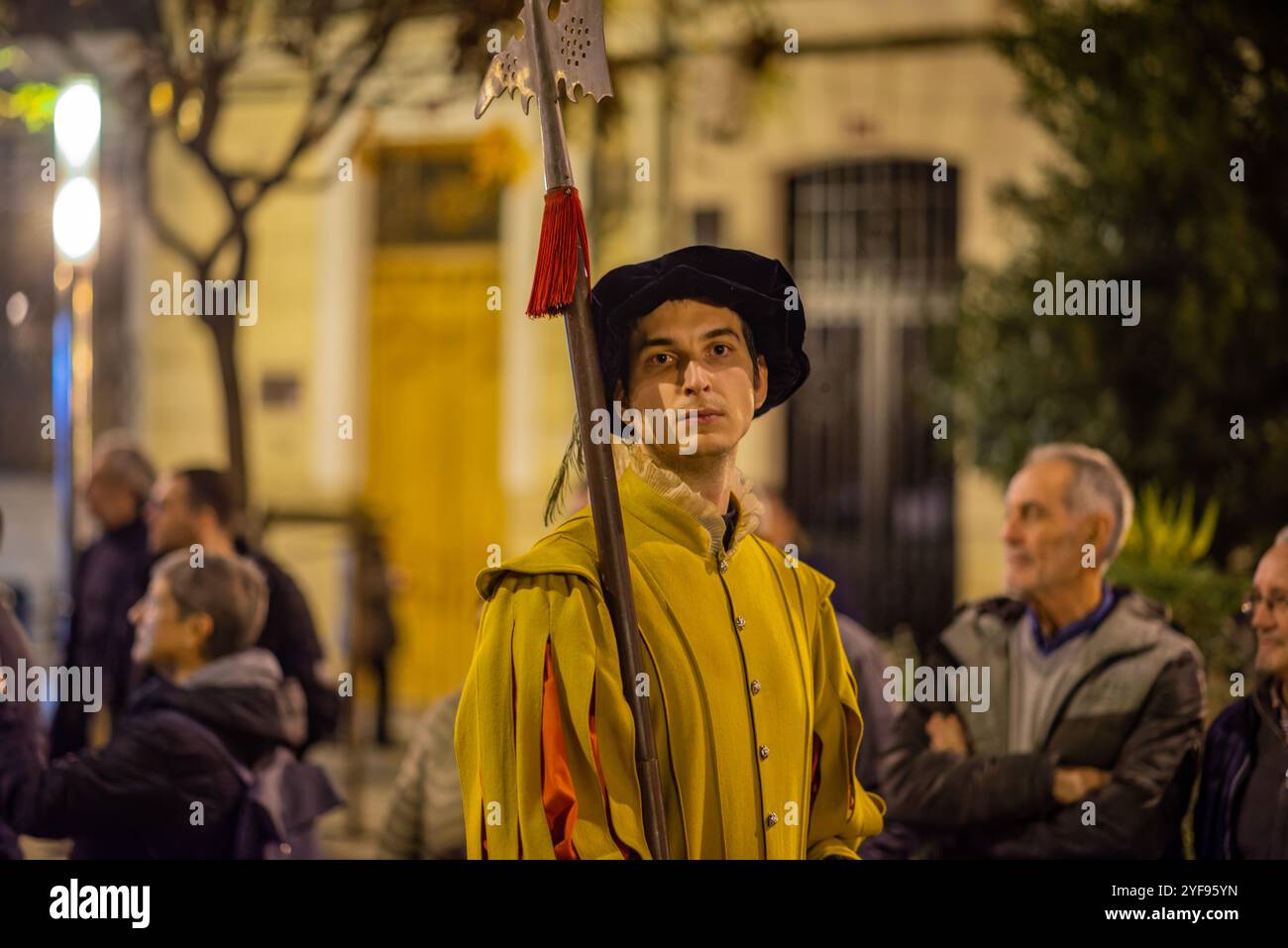 Actor characterized with pale makeup and costumes with flames in night ...