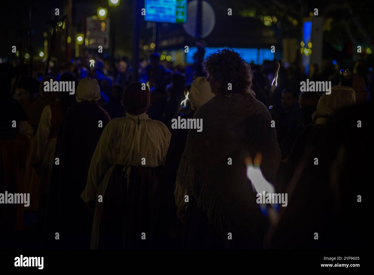 Actor characterized with pale makeup and costumes with flames in night ...