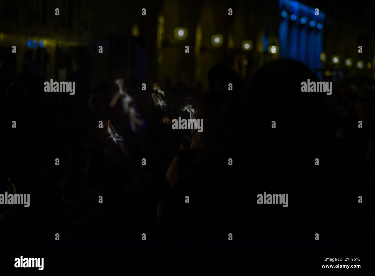 Actor characterized with pale makeup and costumes with flames in night ...